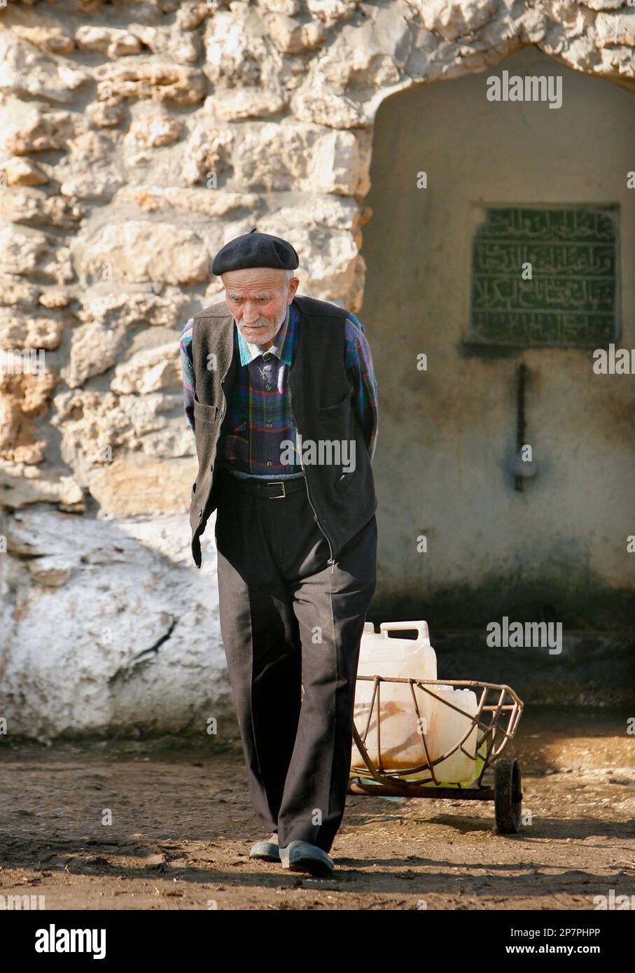 In this Friday, Nov. 27, 2009 photo, an elderly ethnic Turk carries ...