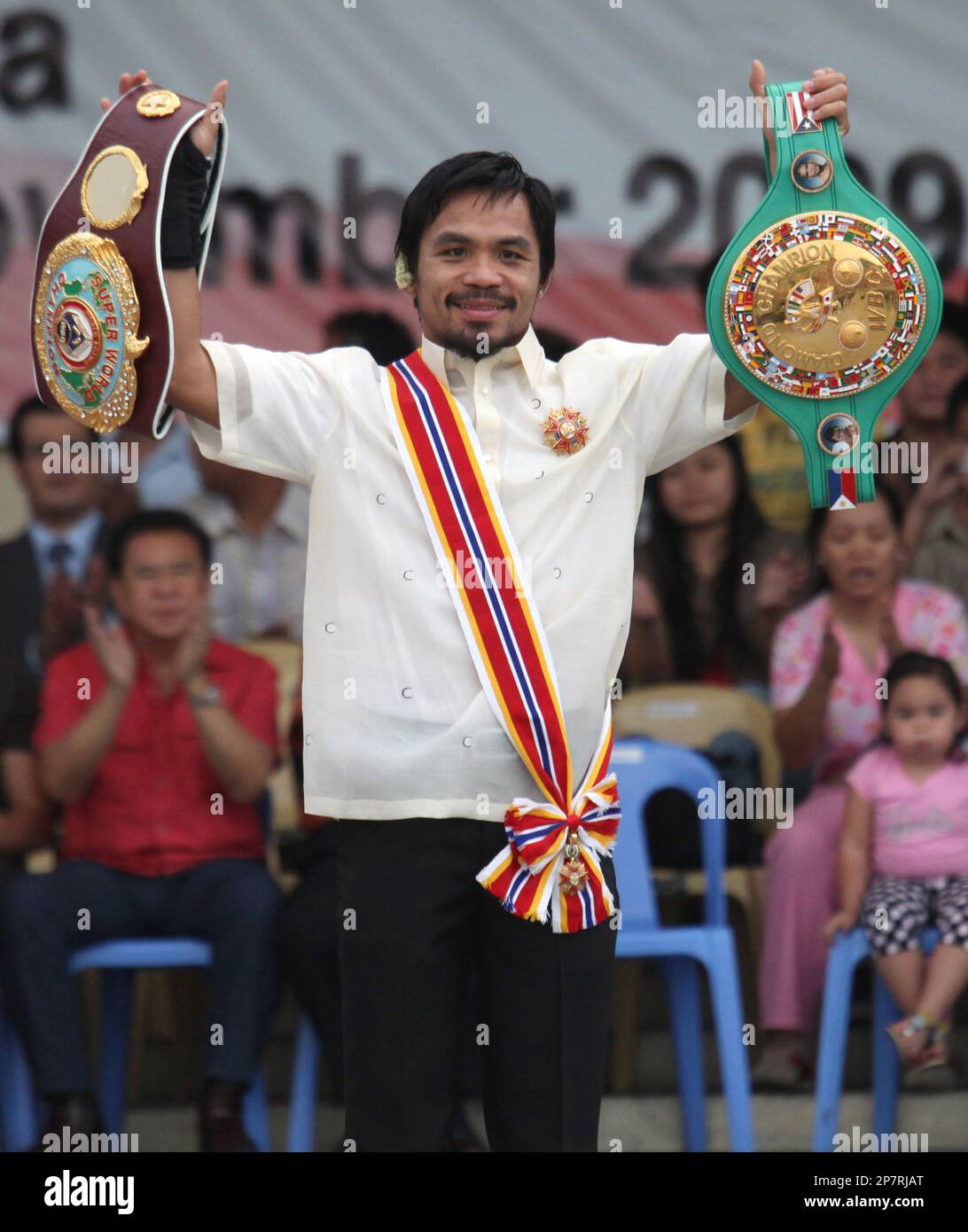Filipino boxing great Manny Pacquiao shows his championship belts as he ...