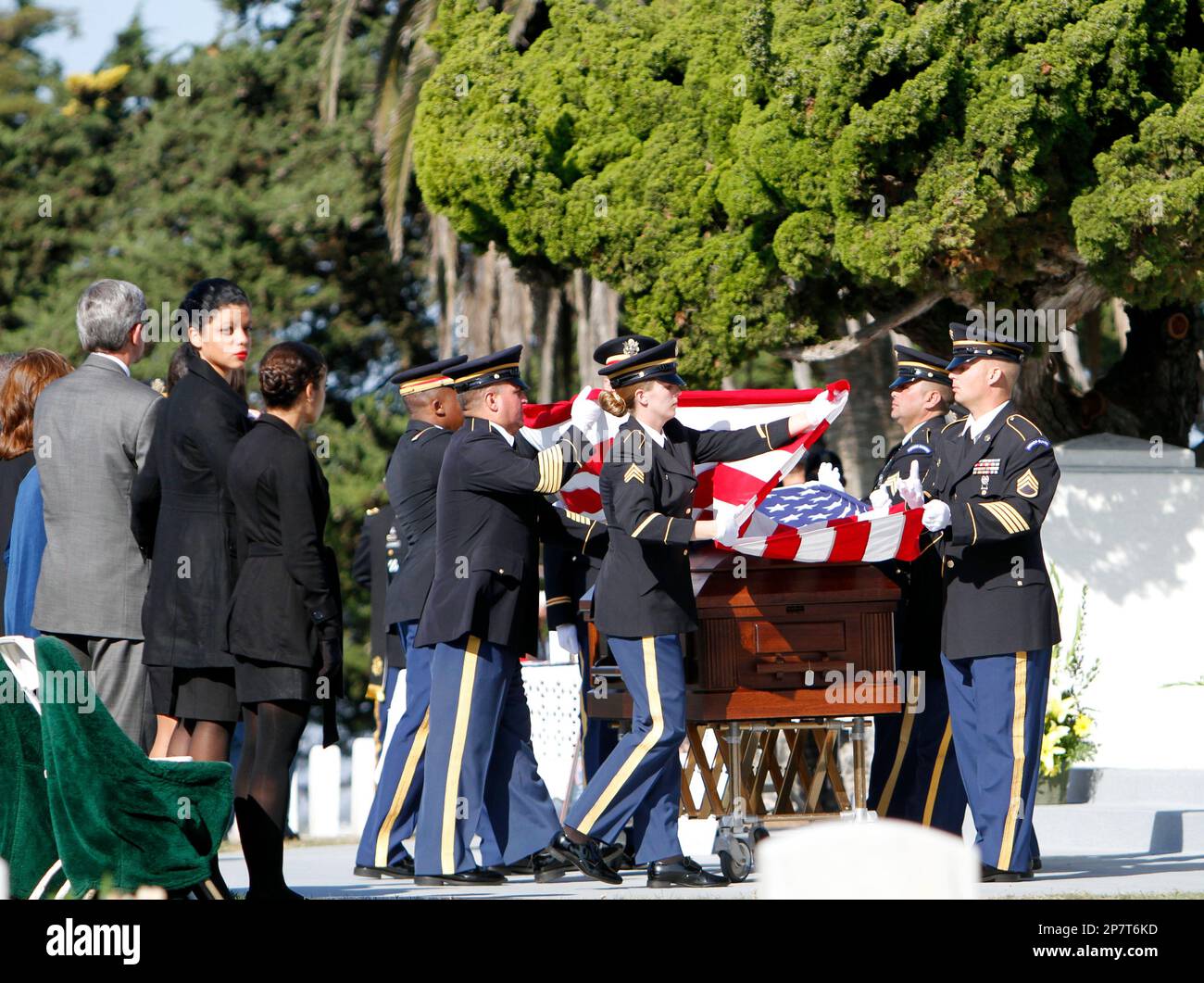 A Honor Guard folds the flag from the casket of Fort Hood victim ...