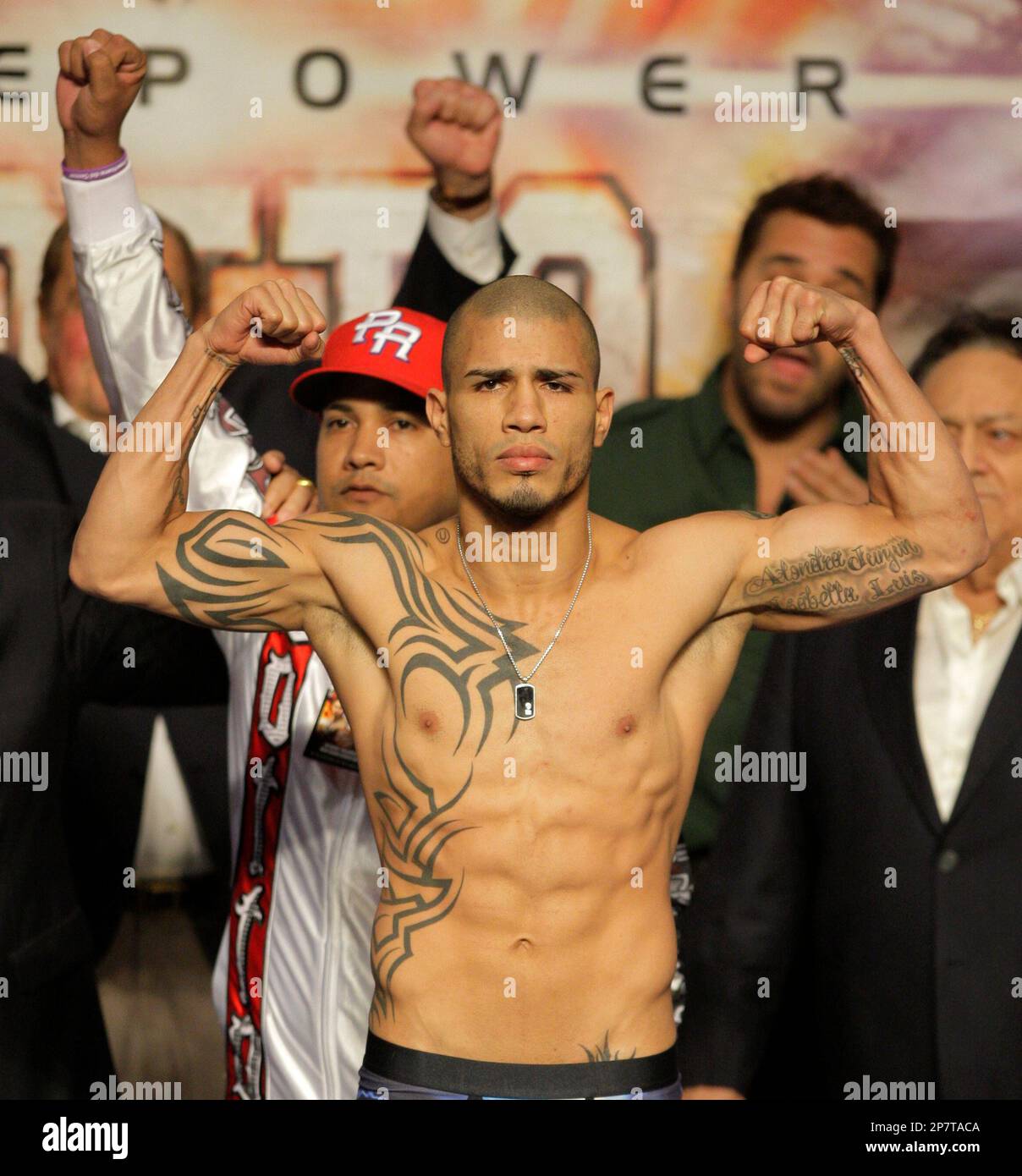 Miguel Cotto, right, of Puerto Rico, poses with his trainer Jose ...