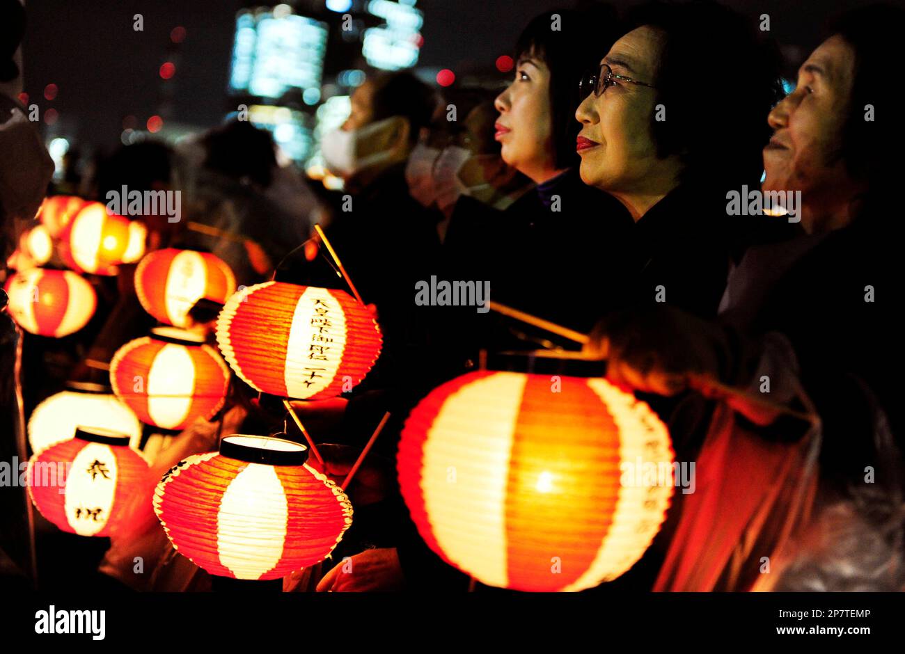 Japanese well-wishers hold paper lanterns while watching Emperor ...