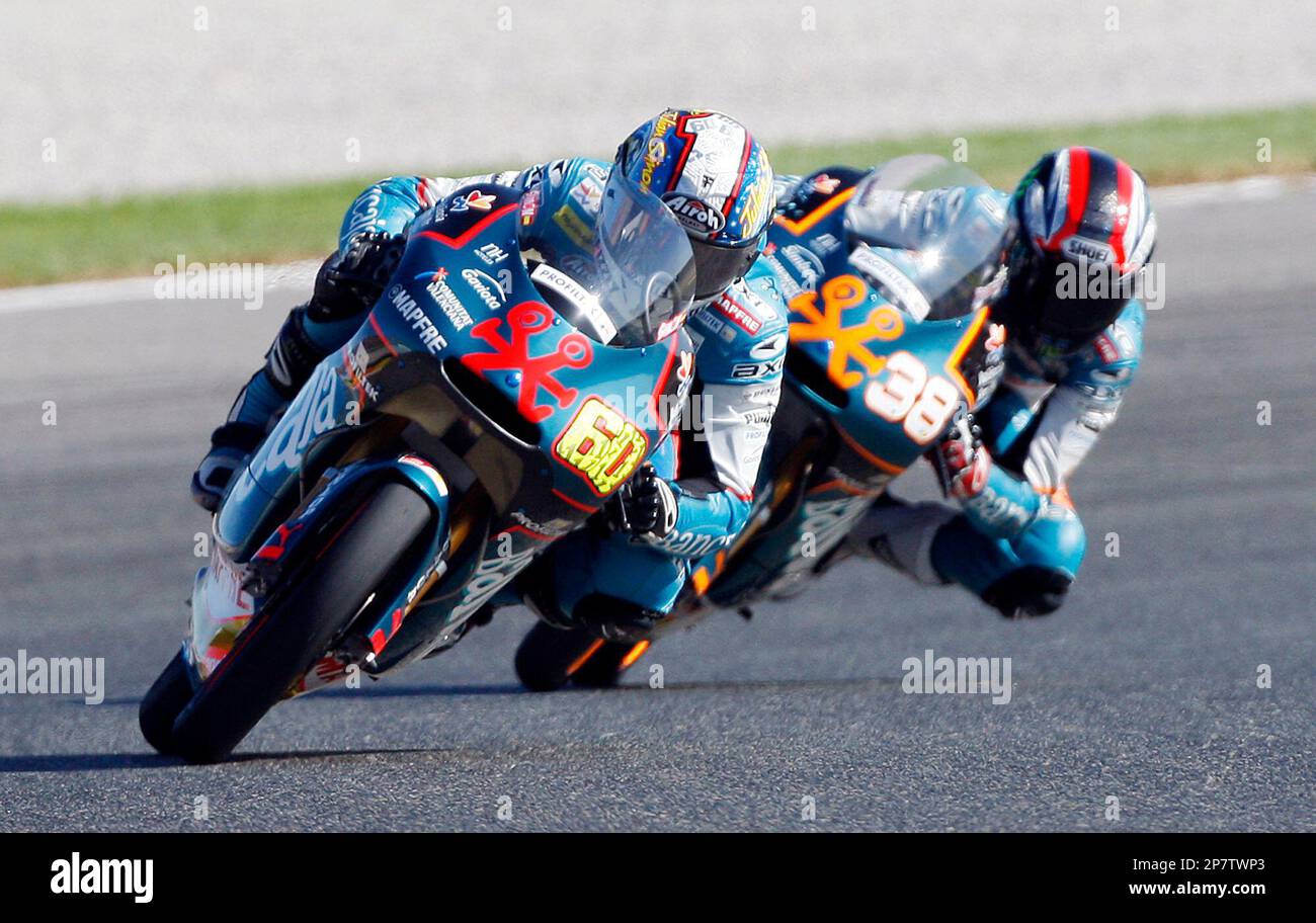 125cc race winner, Aprilia rider Julian Simon of Spain, left leads team ...