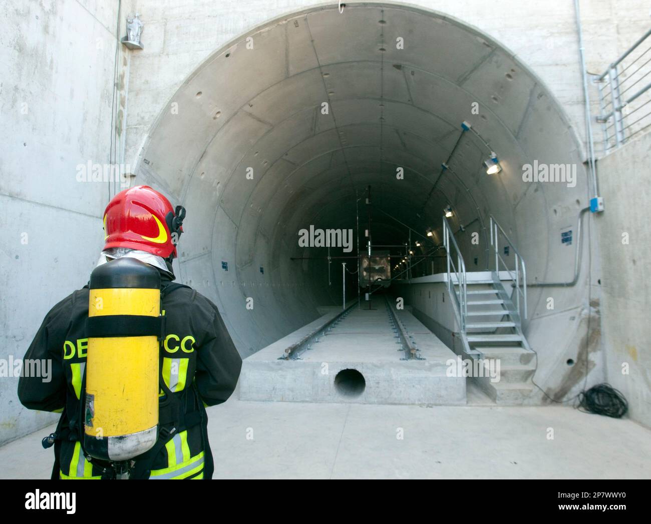 A firefighter looks on during the simulation of a fire on a real size ...