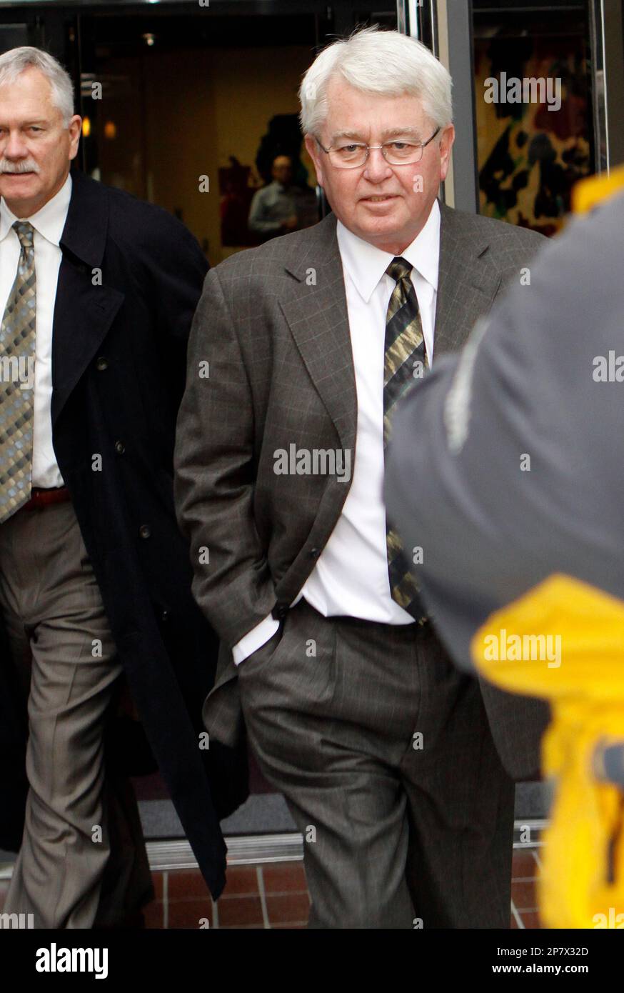 Rick Smith, a VECO Corp. vice president, right, walks out from federal ...