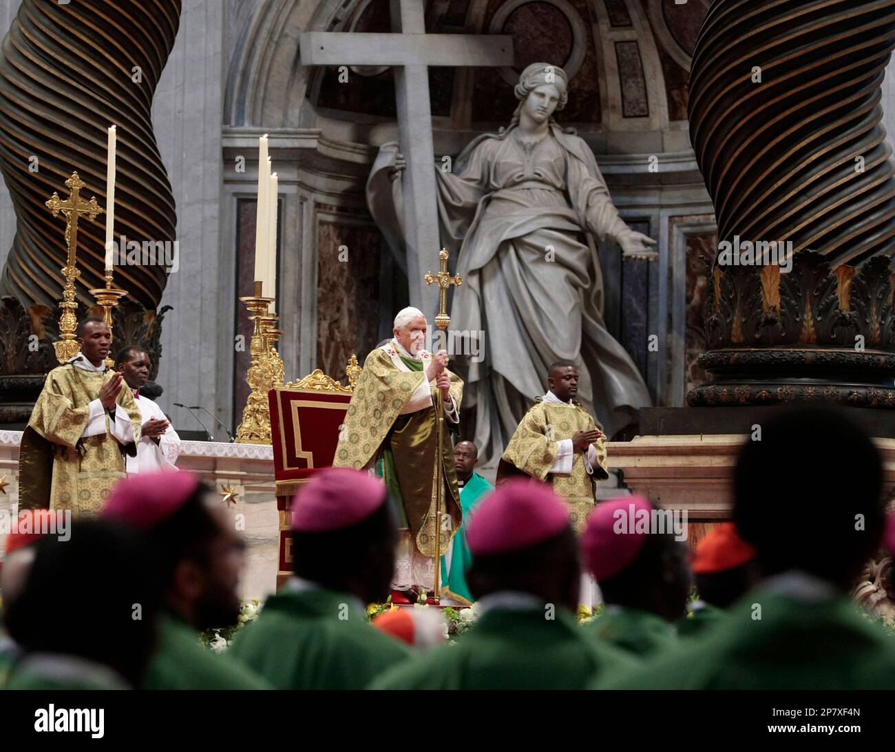 Pope Benedict XVI, background center, holds the pastoral staff as he ...