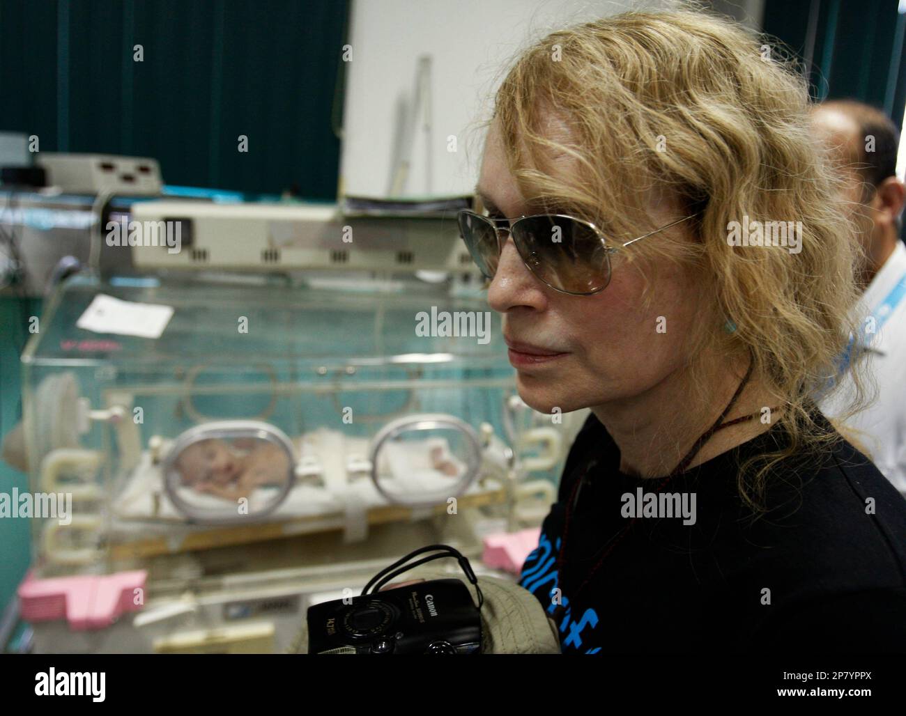 Actress and human rights activist Mia Farrow, right, walks past a ...