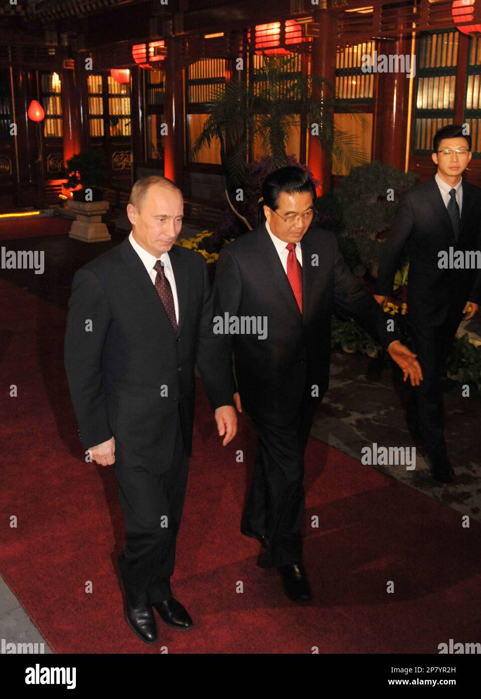 Russian Prime Minister Vladimir Putin, left, walks with Chinese ...