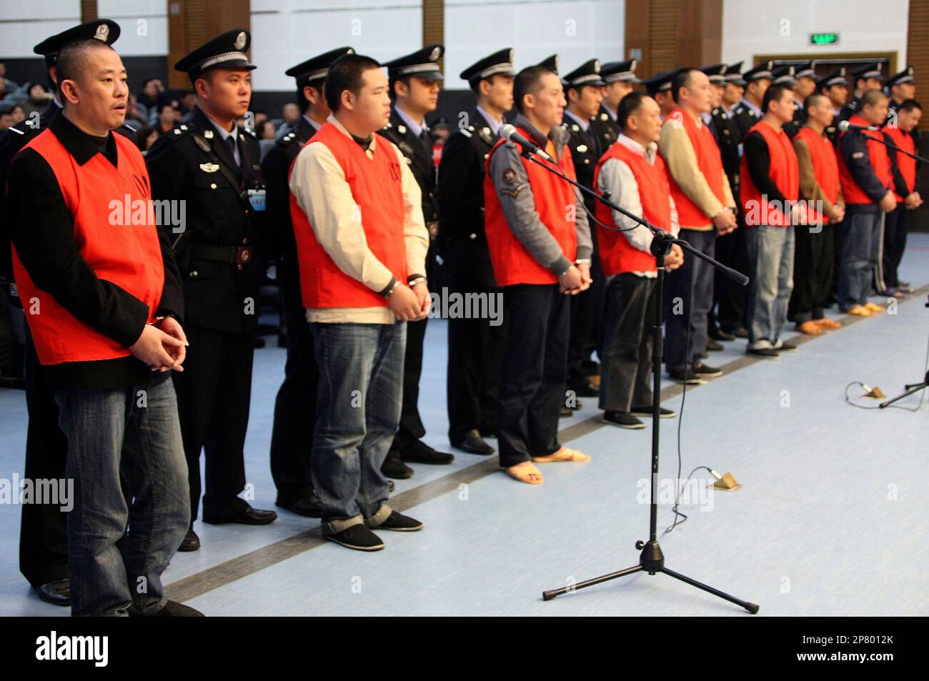 Alleged ganster boss Yang Tianqing, left, and other suspects attend the ...