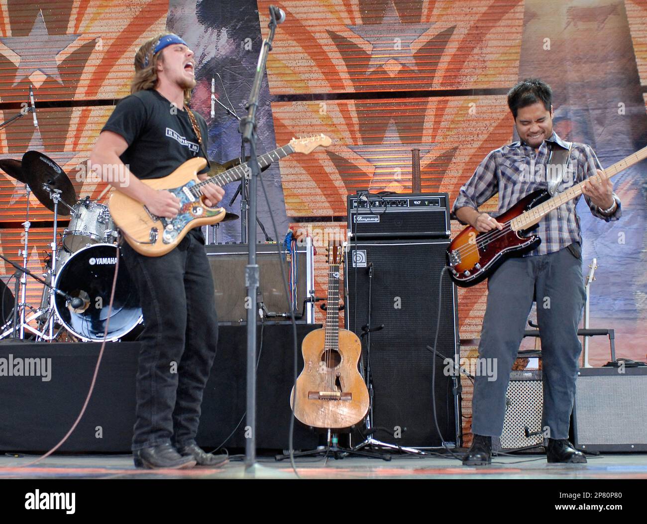 Lukas Nelson, left, performs with bass player JP Maramba, right, and ...