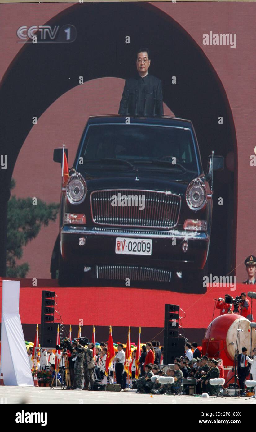 A large screen shows Chinese President Hu Jintao entering Tiananmen ...