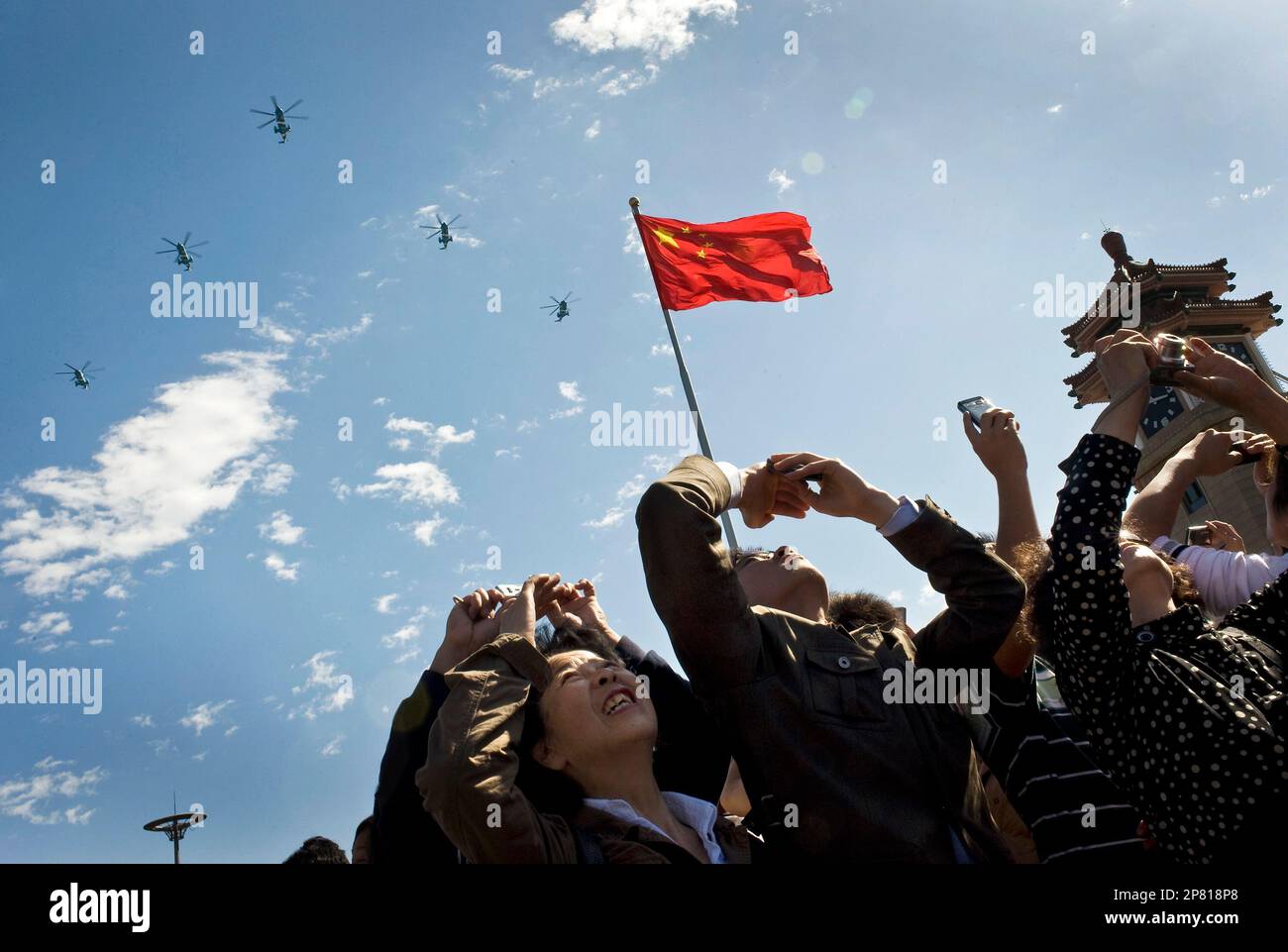 Peoples watch Chinese People's Liberation Army helicopters fly in ...