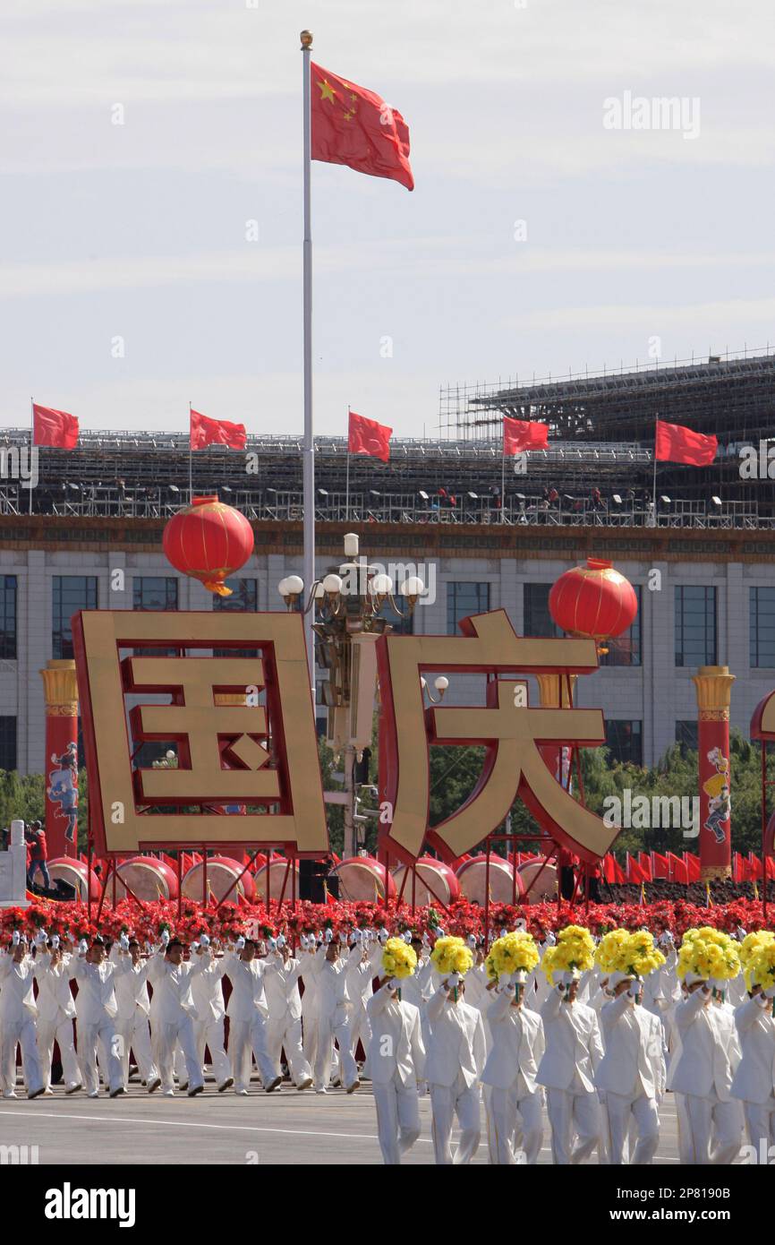 People march by Tiananmen Square during a military parade marking China ...