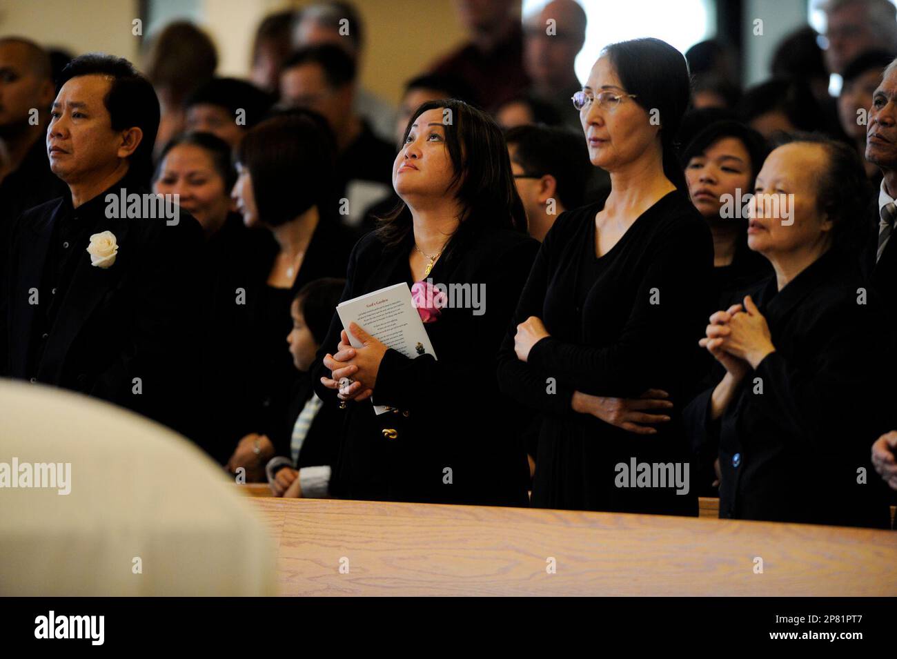 Annie Le's father Hoang Le, left, and mother Vivian Le, looking upward ...