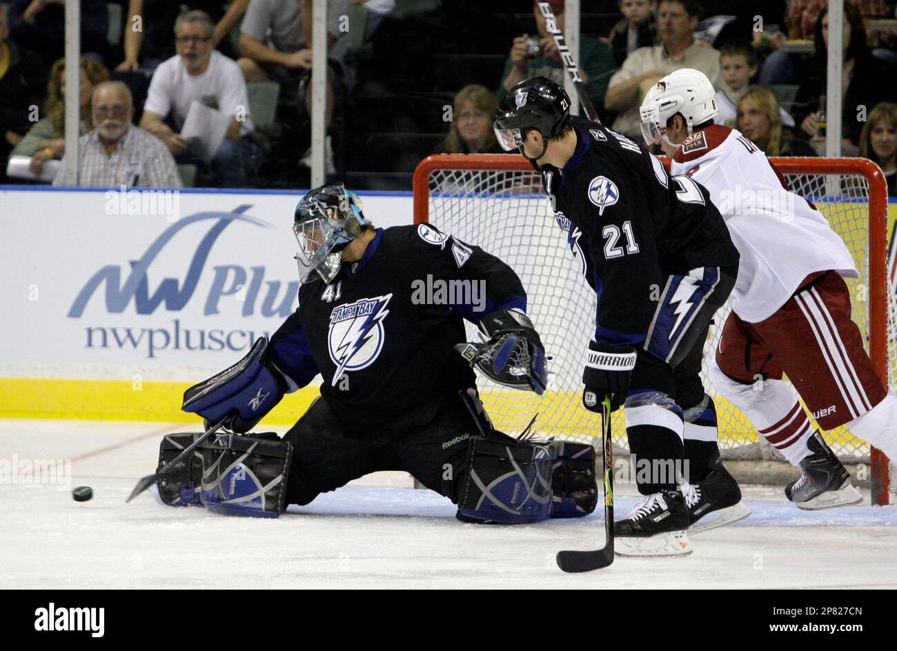 Tampa Bay Lightning goalie Mike Smith, left, deflects the puck as David ...