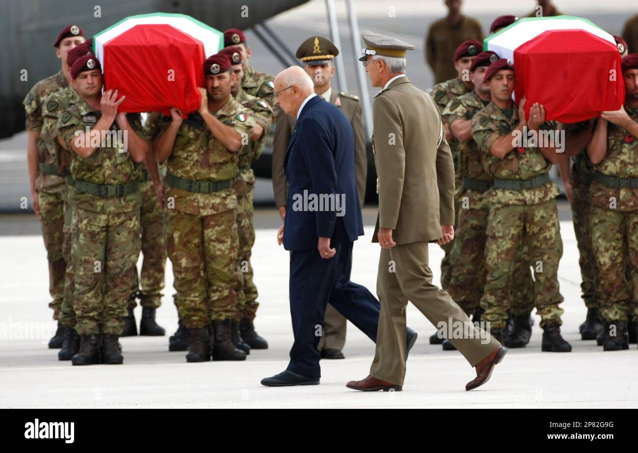 Italian president Giorgio Napolitano walks past the coffins of the six ...