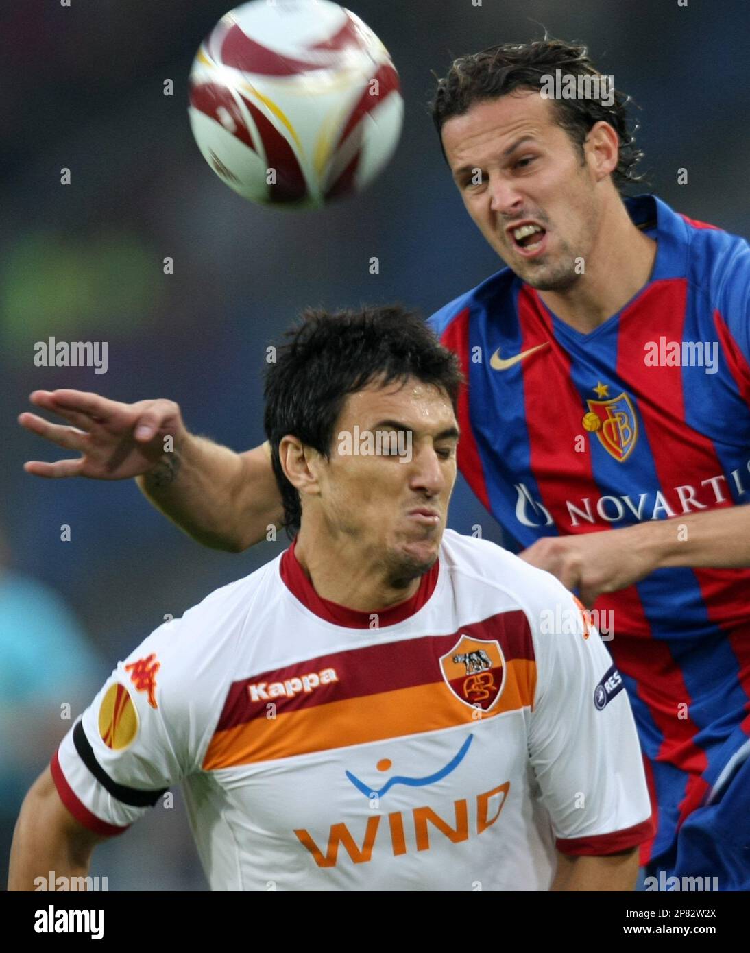 Basel's Marco Streller, right, goes for a header with Rome's Nicolas ...
