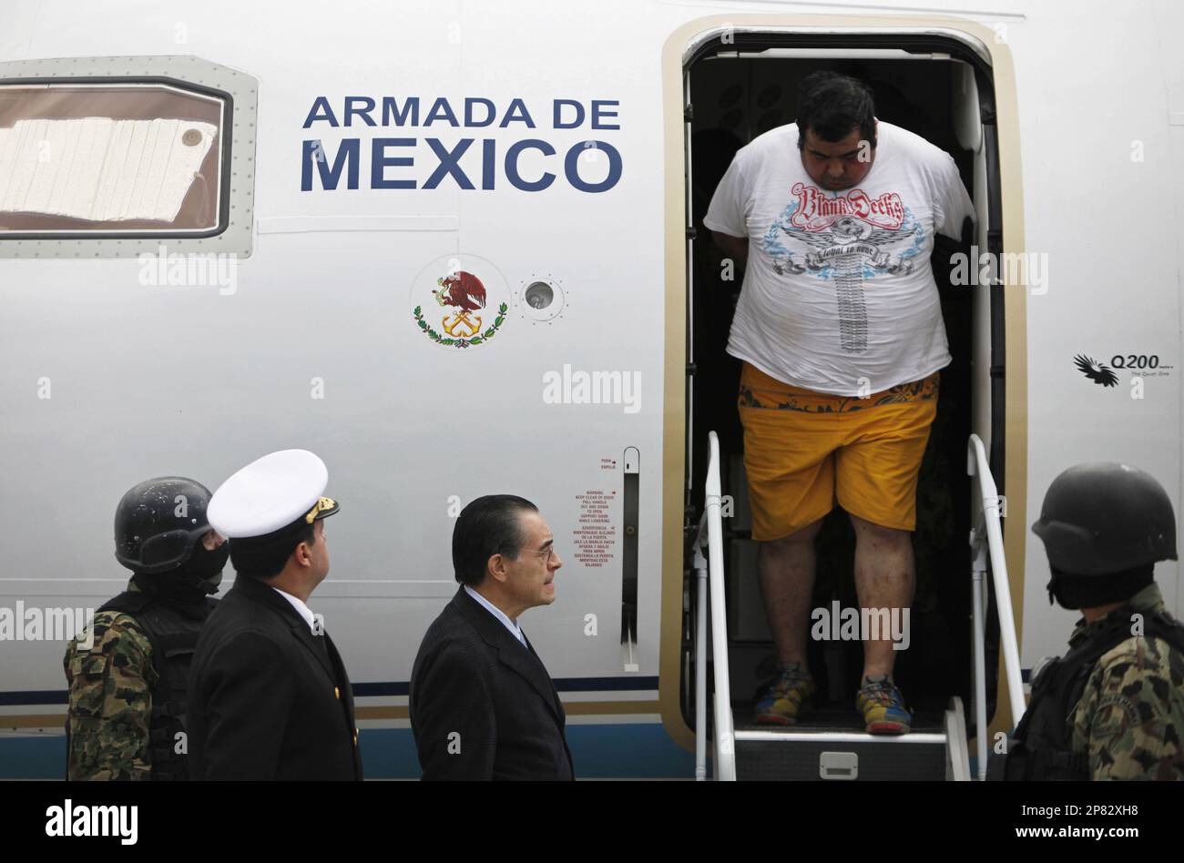 Alleged kidnapper Jose Cruz, top, gets off a military plane prior to ...