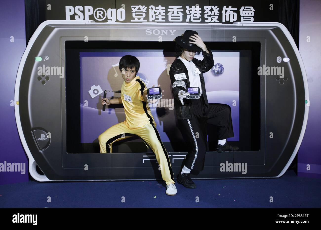 Models dressed as Hong Kong martial arts actor Bruce Lee, left, and U.S ...