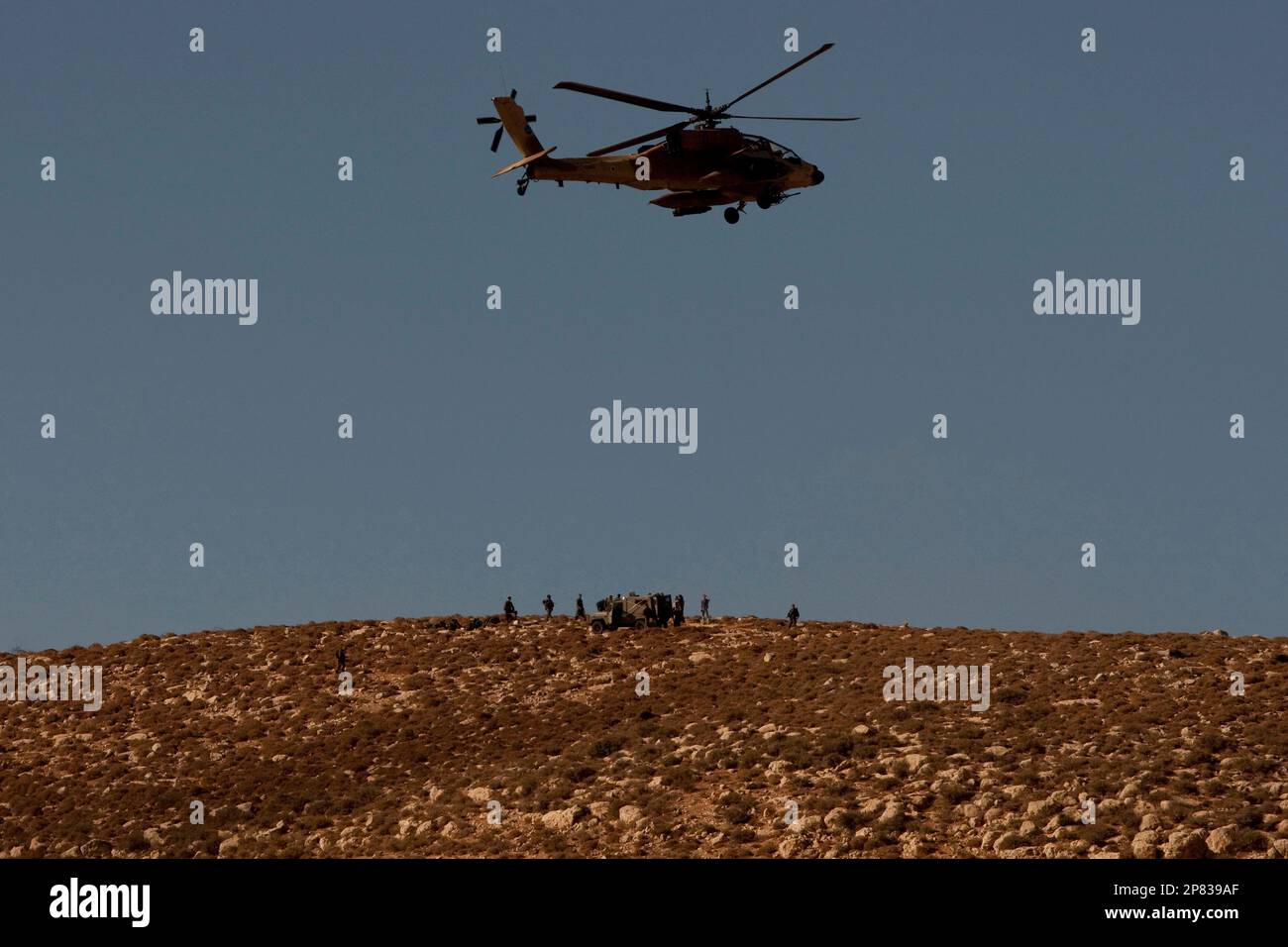 An Israeli air force combat helicopter flies over the crash site of a F ...