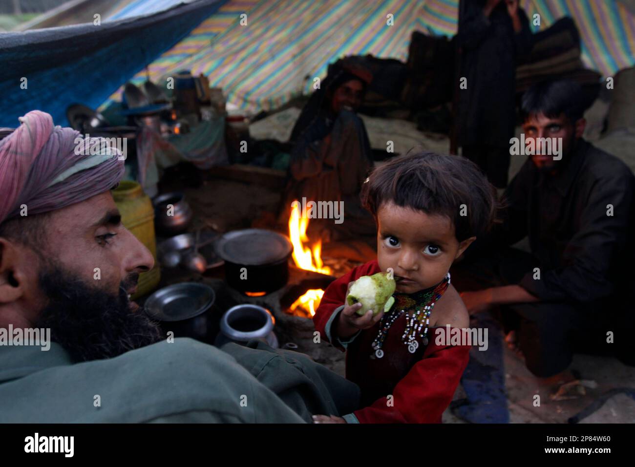 A Kashmiri Bakarwal nomadic family prepare food as they wait to break ...