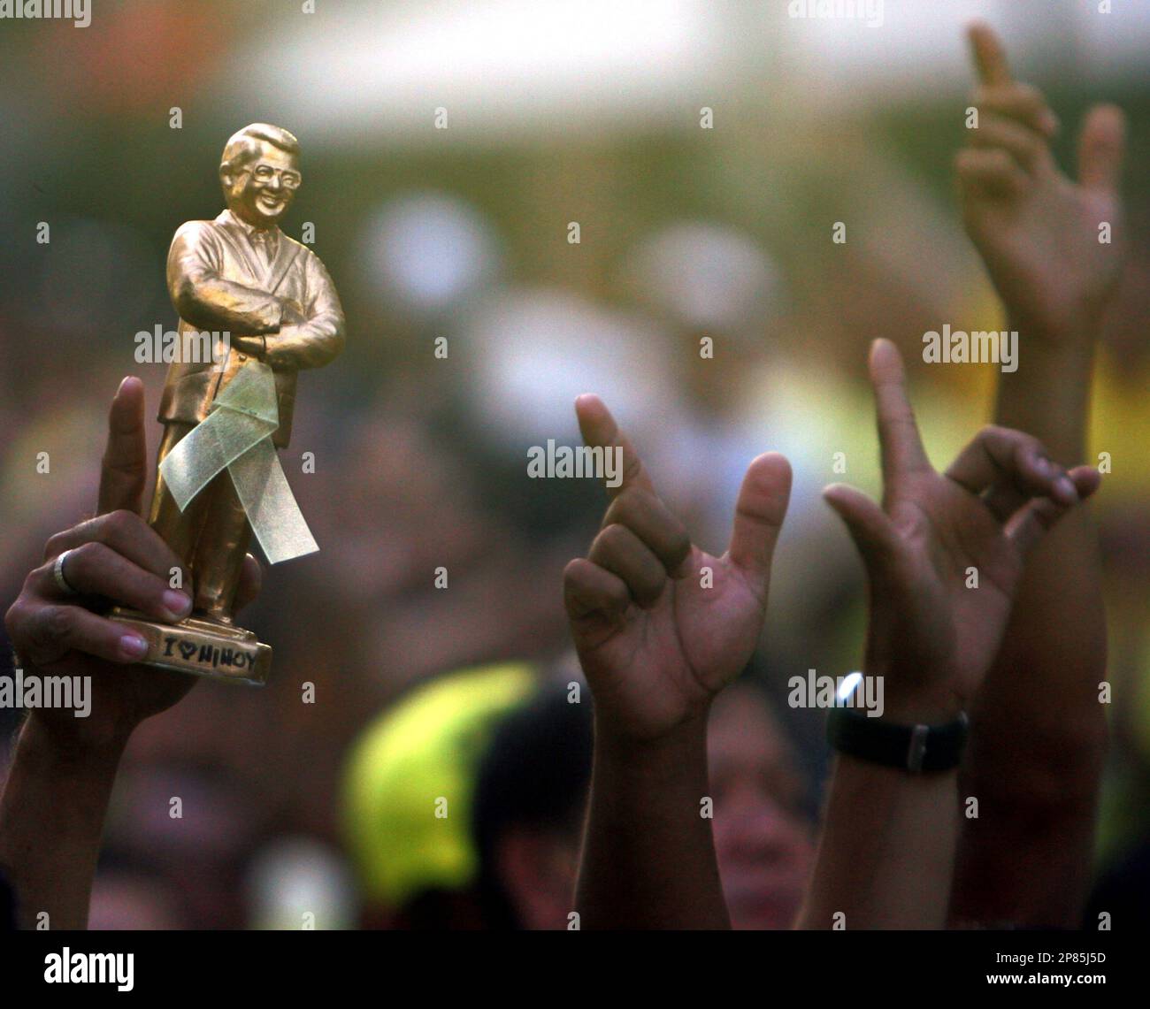 A small statue of the late Senator Benigno Aquino is displayed as other ...