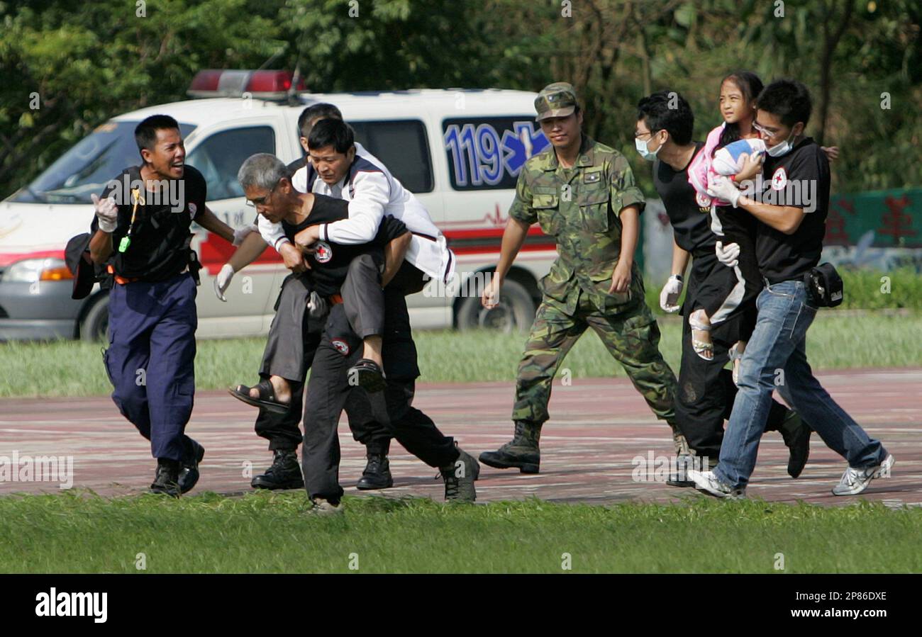 Taiwan military and Red Cross volunteer bring rescued residents trapped ...