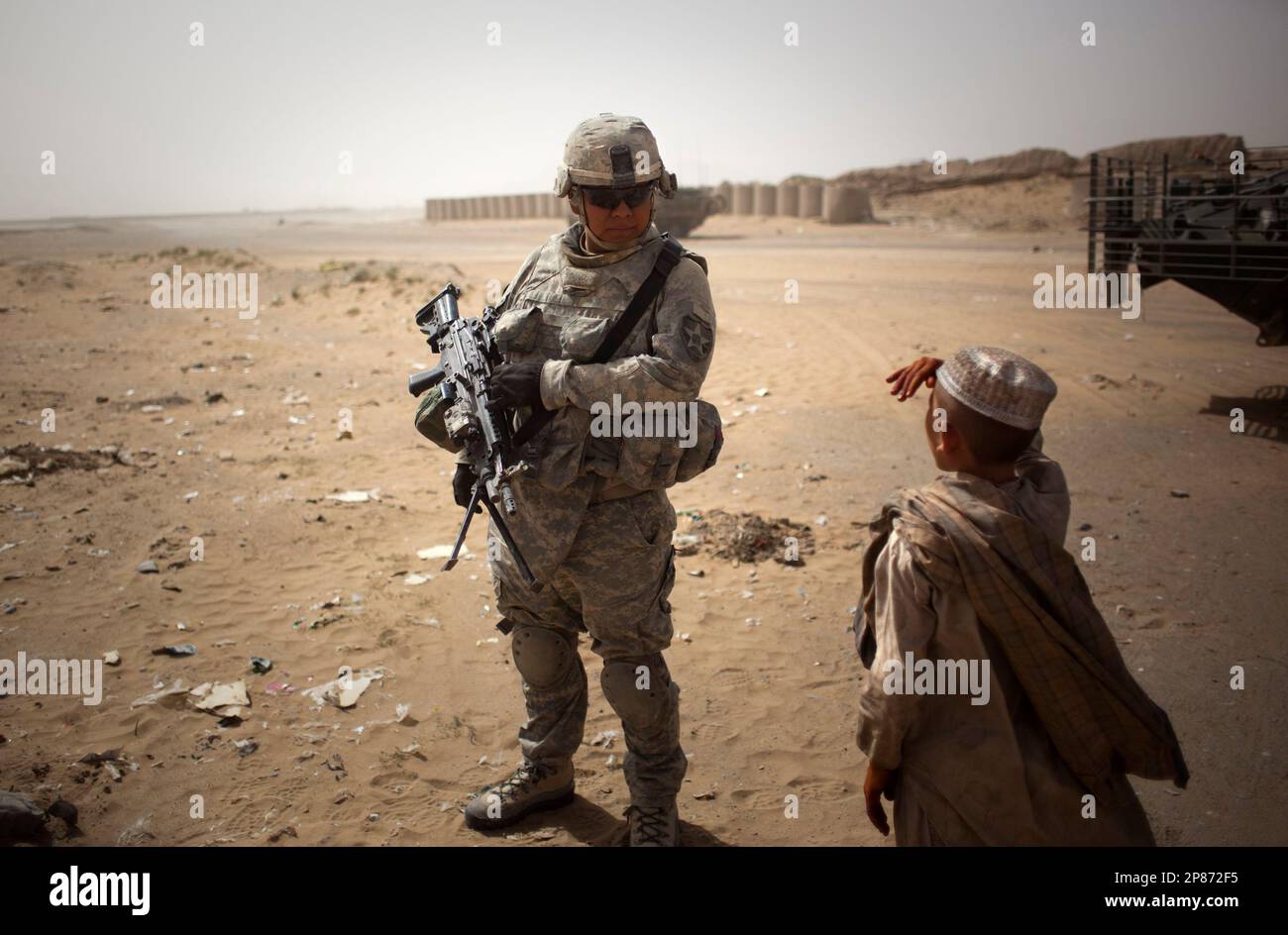 An Afghan boy is seen next to Private First Class U.S. soldier, Ryan ...