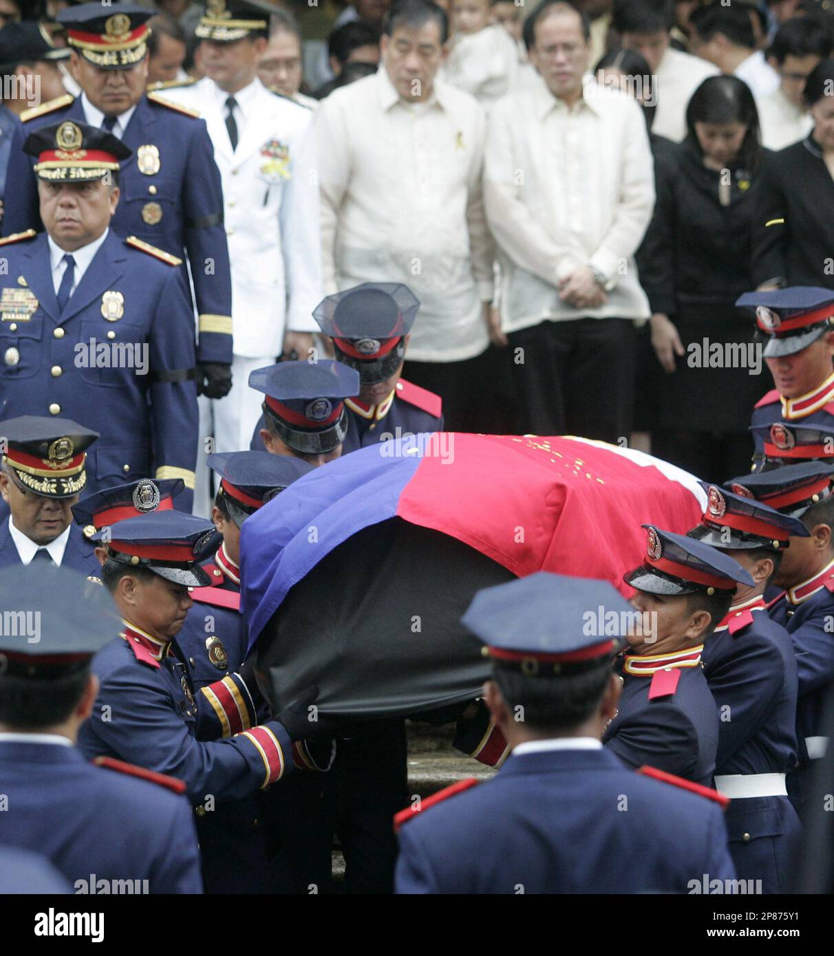 Police pallbearers carry the flag-draped coffin of former Philippine ...