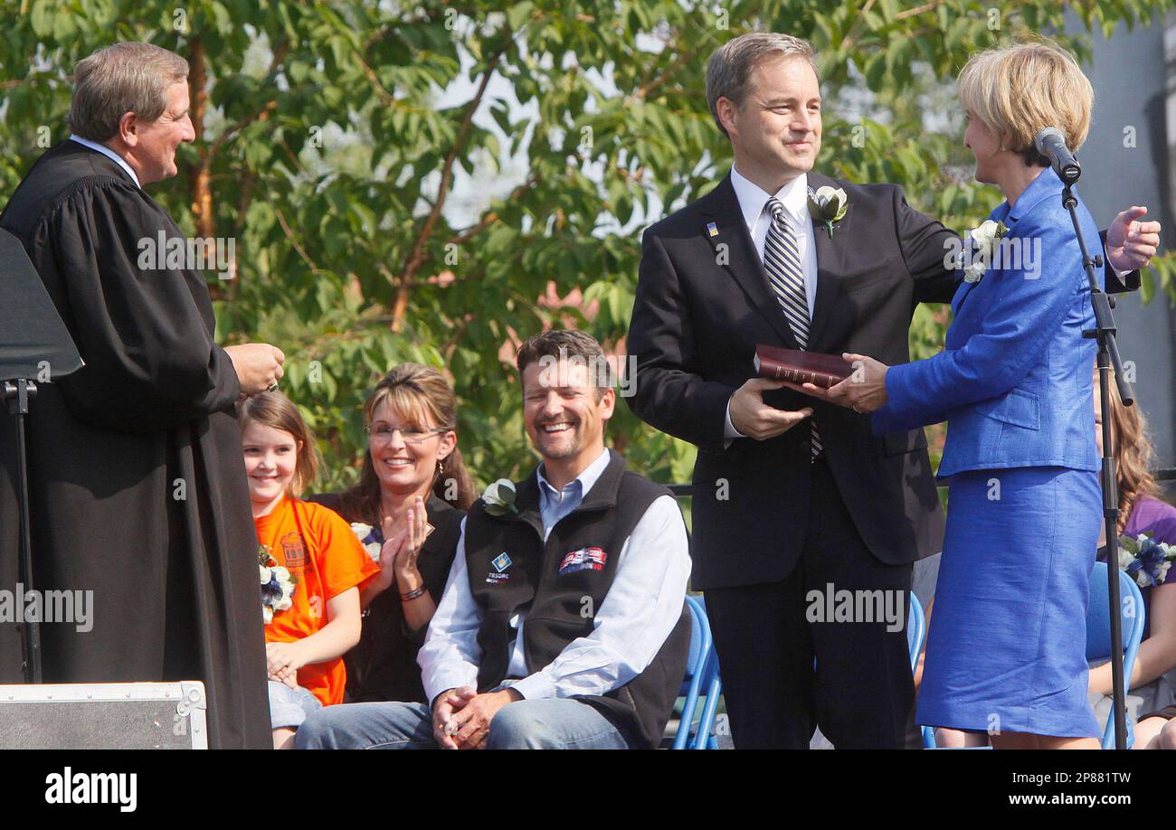 Gov. Sean Parnell, second left goes to hug his wife Sandy, right ...