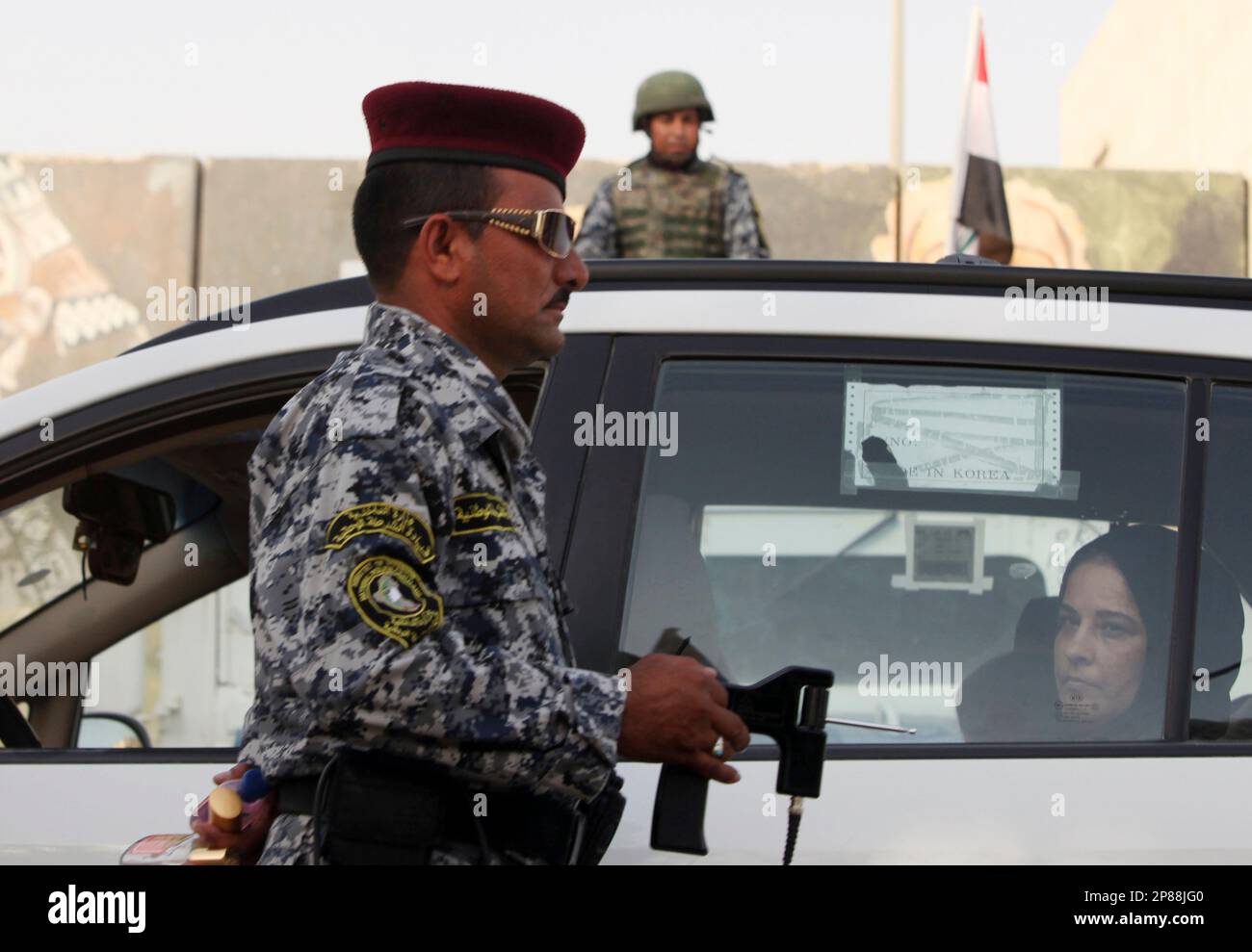 Iraqi policemen stand guard at a checkpoint in Baghdad, Iraq, Monday ...
