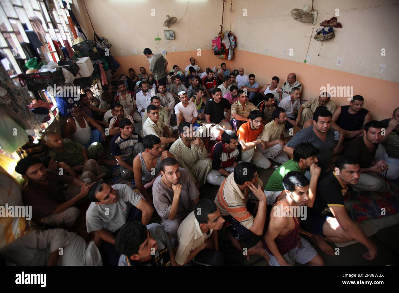 In this June 16, 2009, file photo, men sit in crowded cells in a jail ...