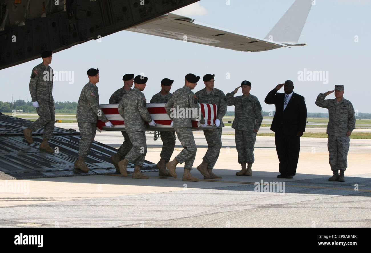 An Army Corps carry team carries the transfer case containing the ...