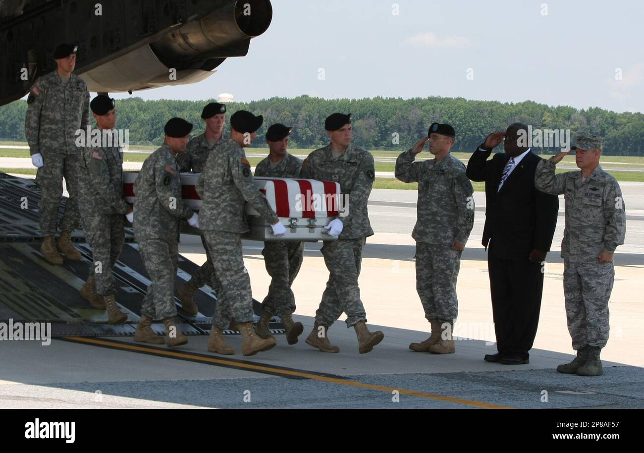 An Army Corps carry team carries the transfer case containing the ...