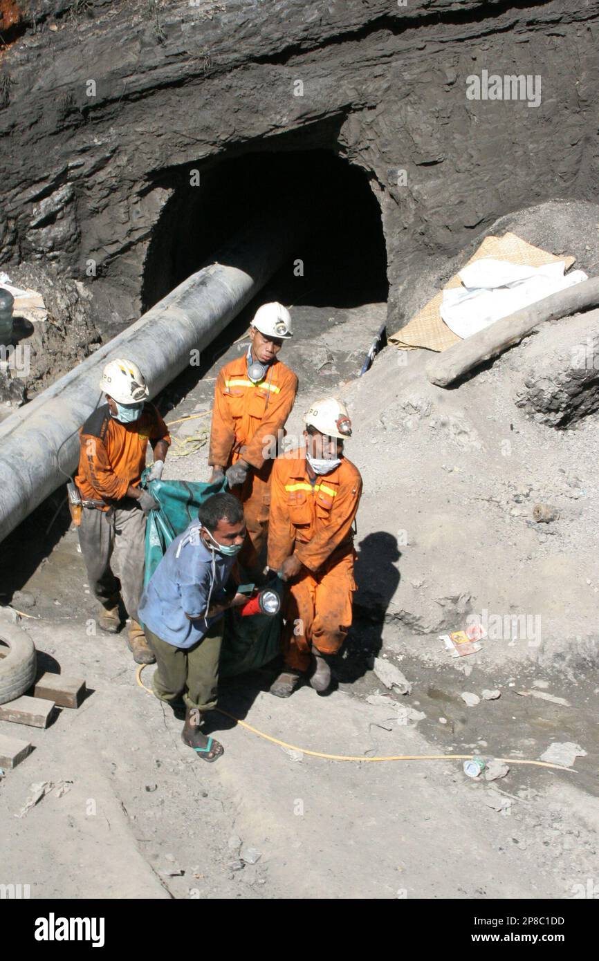 Rescuers carry the body of a victim of mine explosion in Sawahlunto ...
