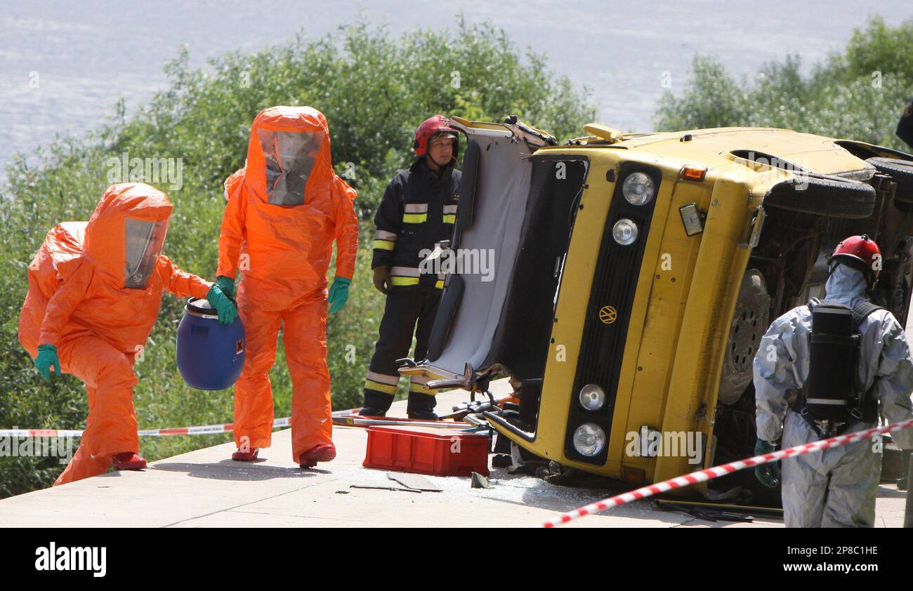 Polish fire fighters practice cleaning up a chemical spill during a ...