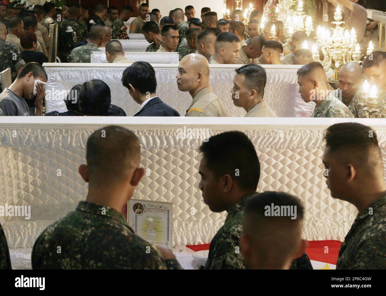 Philippine Marines view the remains of seven fellow marines who were ...