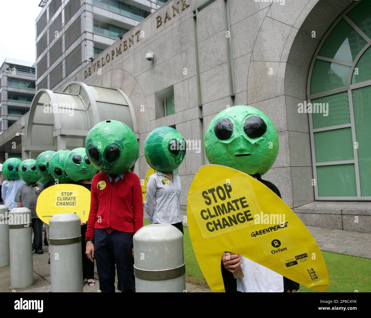 Protesters wearing alien costumes stage a demonstration outside the ...