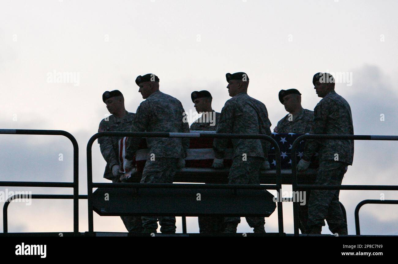 Members of the Army "Old Guard" dignified transfer carry team carry the ...