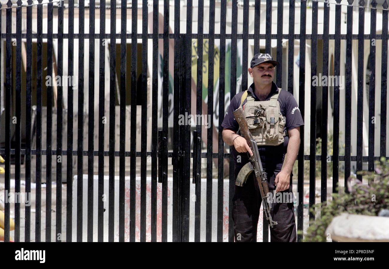 Pakistani police commando stands guard at the main gate of police ...
