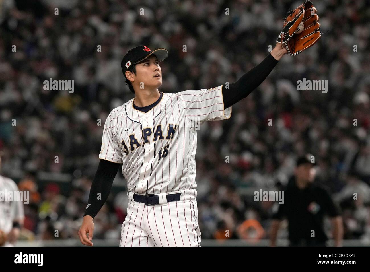Shohei Ohtani of Japan catches a ball on the mound in the first inning of the Pool B game ...