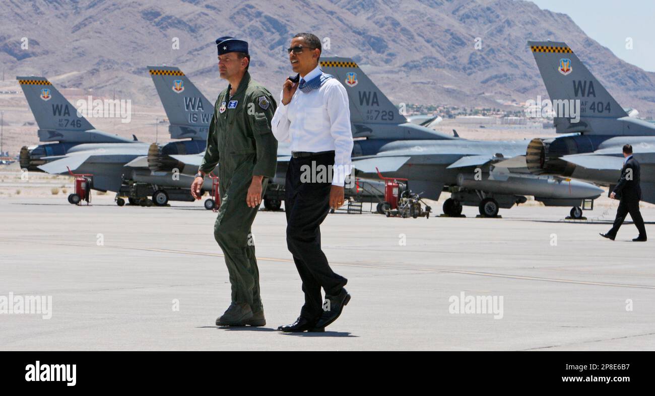 President Barack Obama walks with Brig. Gen. Ted Kresge past F-16 ...