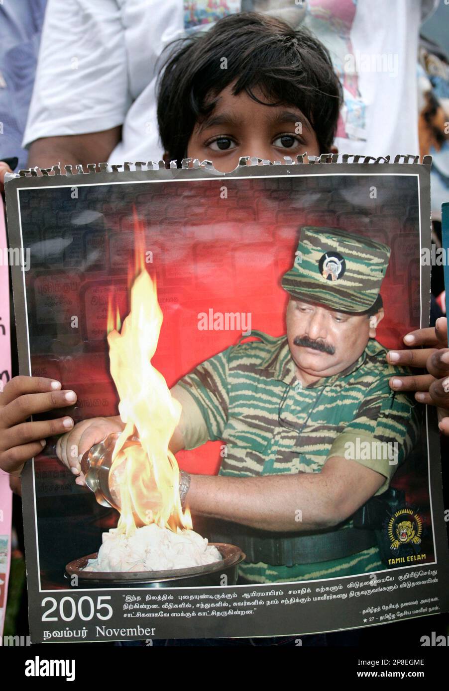 A young Malaysian Indian protester of Tamil ethnicity holds a poster of ...