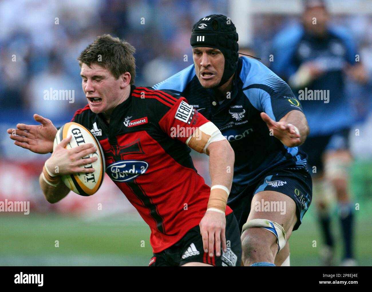 New Zealand Crusaders Adam Whitelock, left, runs with the ball as South ...