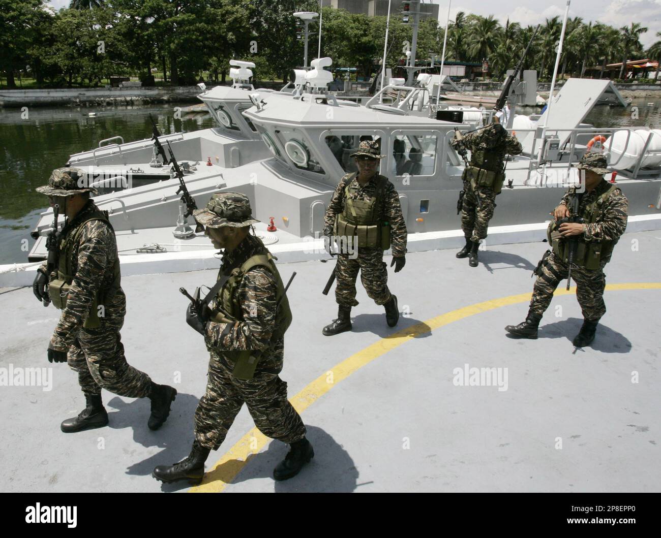 Philippine Navy SEALS walk past three newly-acquired Multi-purpose ...