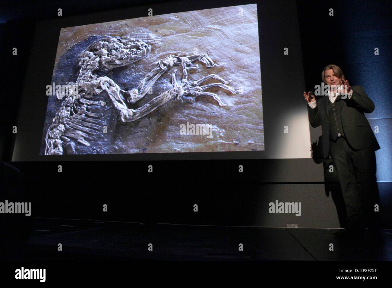 Dr. Jorn Hurum speaks to reporters as a photo of the 47 million-year ...
