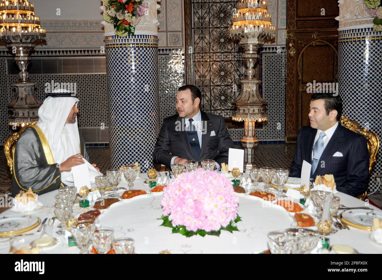 In this photo released by the Royal Palace Morocco's king Mohammed VI, centre, chats with Sheik ...