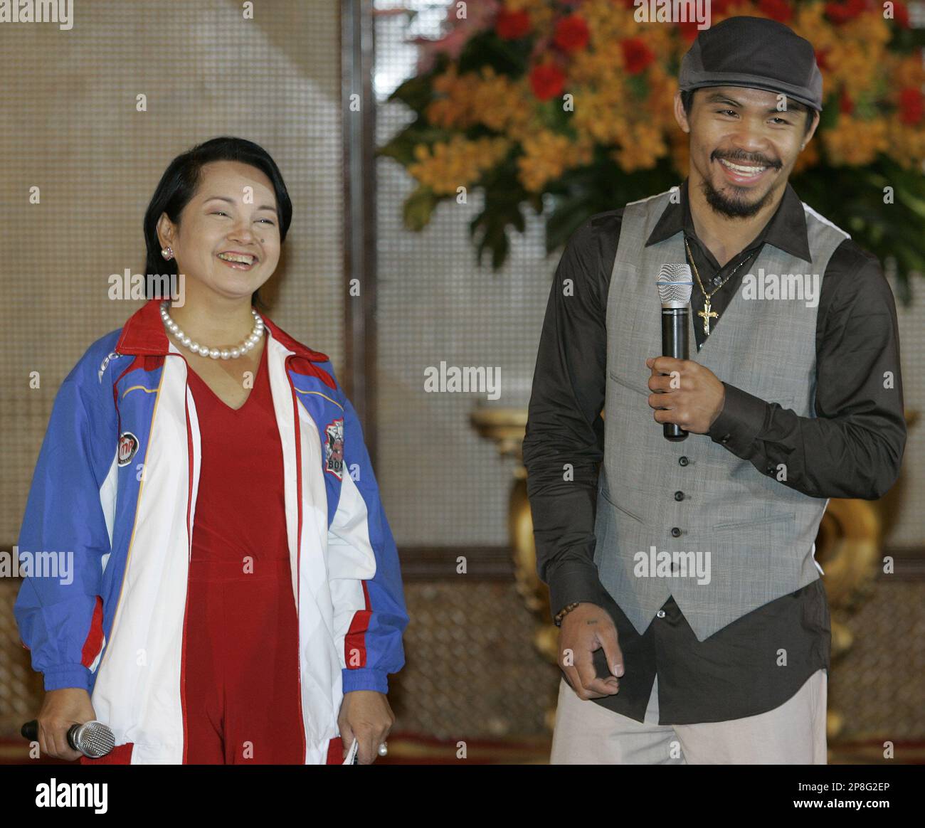 Philippine President Gloria Macapagal Arroyo, left, smiles with ...