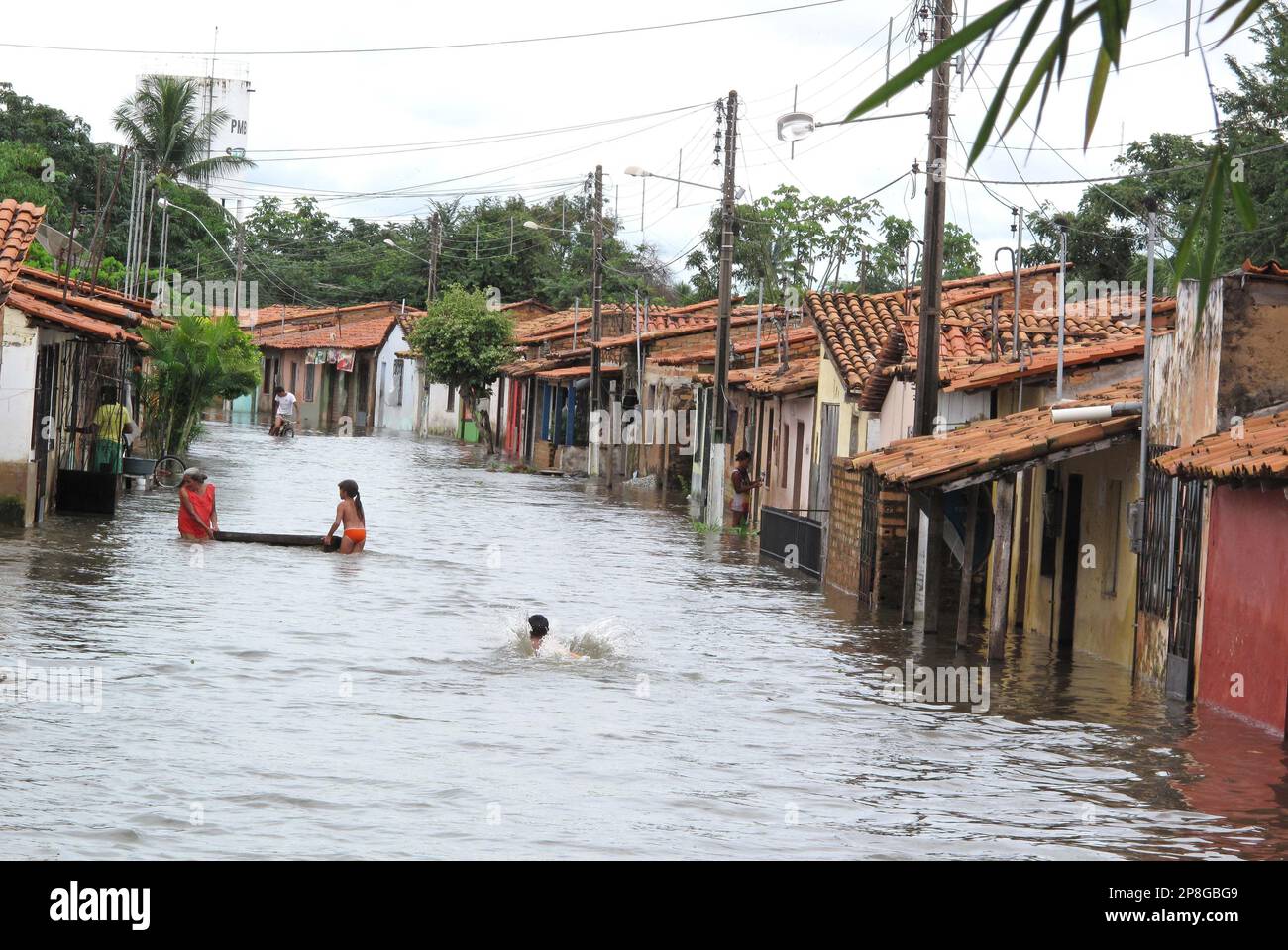 People cross a flooded in Bacabal, in the Brazilian northeastern state ...