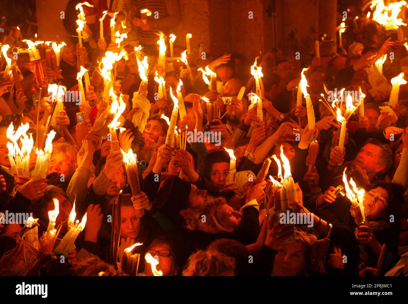 Christian Orthodox pilgrims hold candles at the Church of the Holy ...