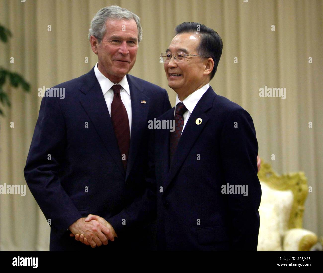Chinese Premier Wen Jiabao, right, shakes hands with former U.S ...